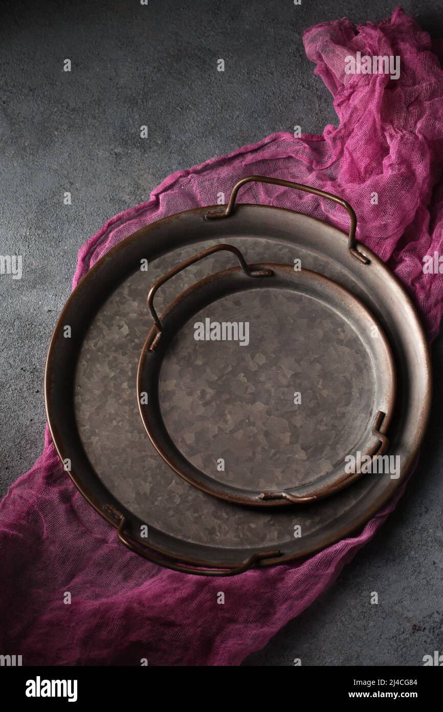 Two vintage metal trays on a gray background Stock Photo - Alamy