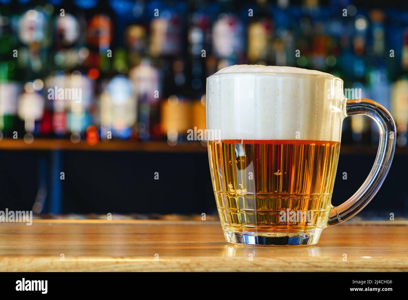 Fresh cold beer in glass on bar background Stock Photo - Alamy