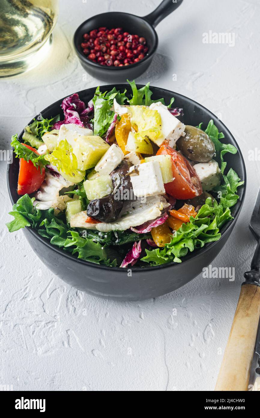 Greek salad with tomato pepper, olives and feta cheese, on white ...