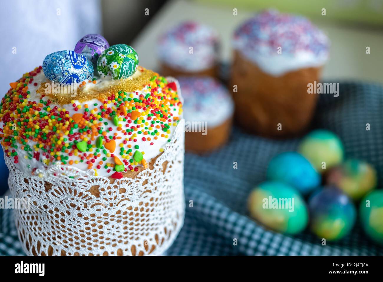 Traditional Easter cake with glace icing and painted easter eggs.Rustic ...