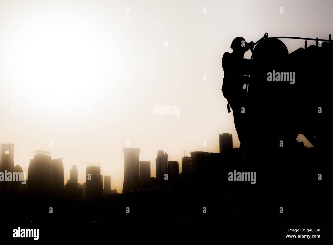 Doha,Qatar - 19/04/2022 : Construction workers preparing a crane for ...