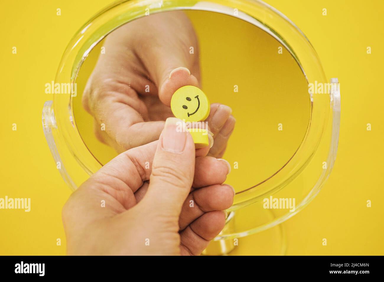 Conceptual image of happiness and wellness of a smiley face reflected ...