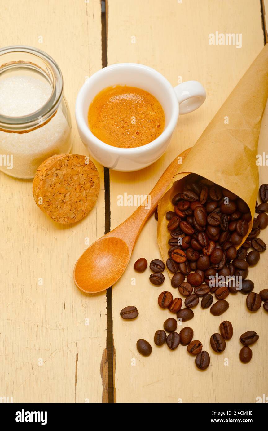 Espresso coffee and beans on a paper cone cornucopia over white ...