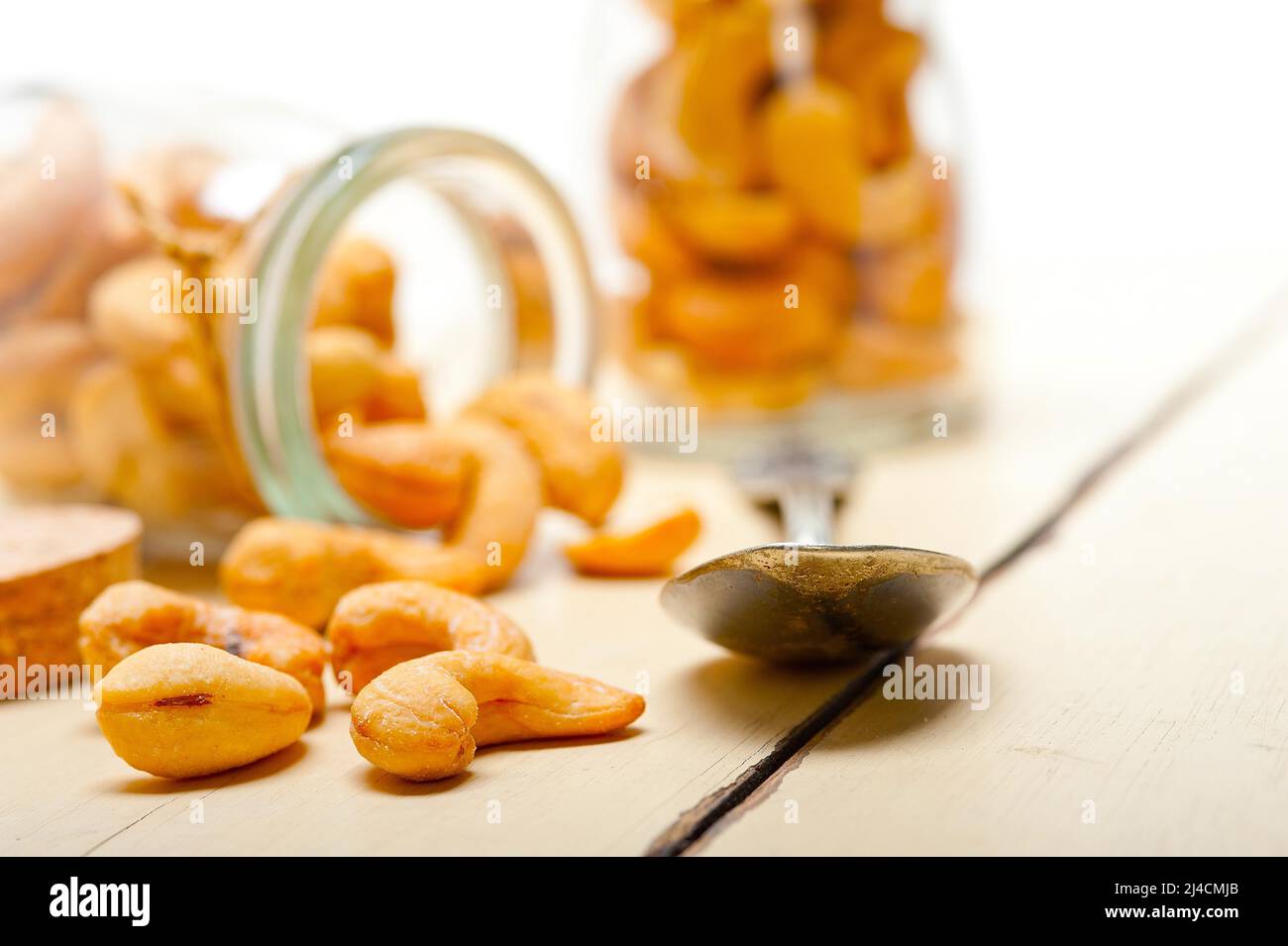 Cashew nuts on a glass jar over white rustic wood table Stock Photo - Alamy