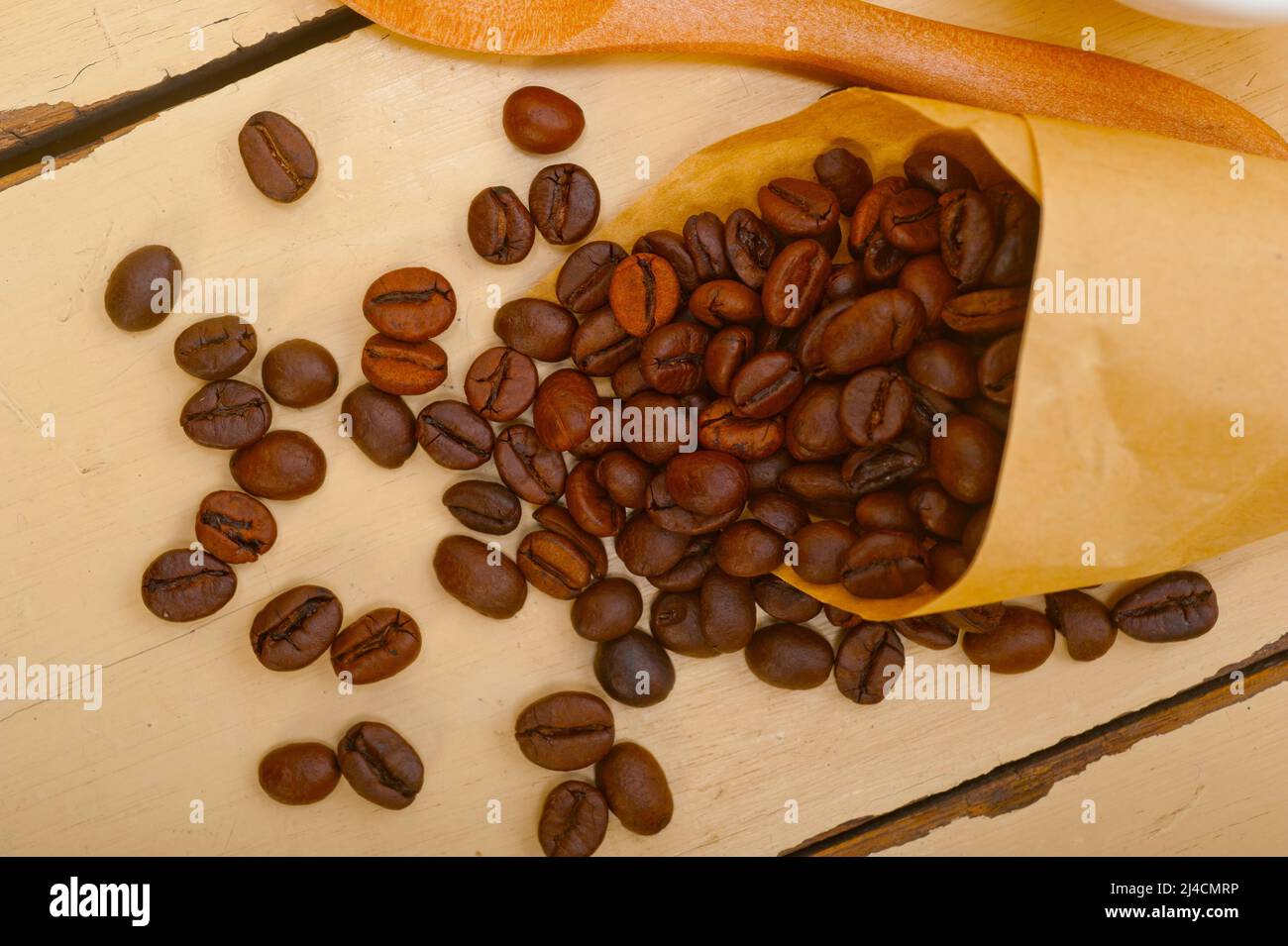 Espresso coffee and beans on a paper cone cornucopia over white ...