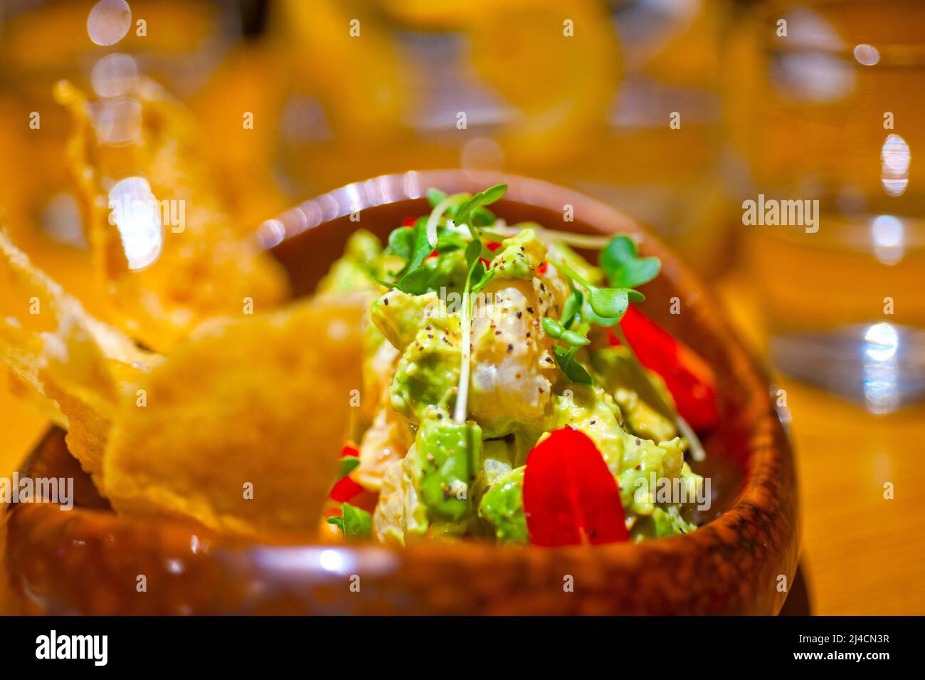 Fresh avocado and shrimps salad with nachos on side Stock Photo - Alamy