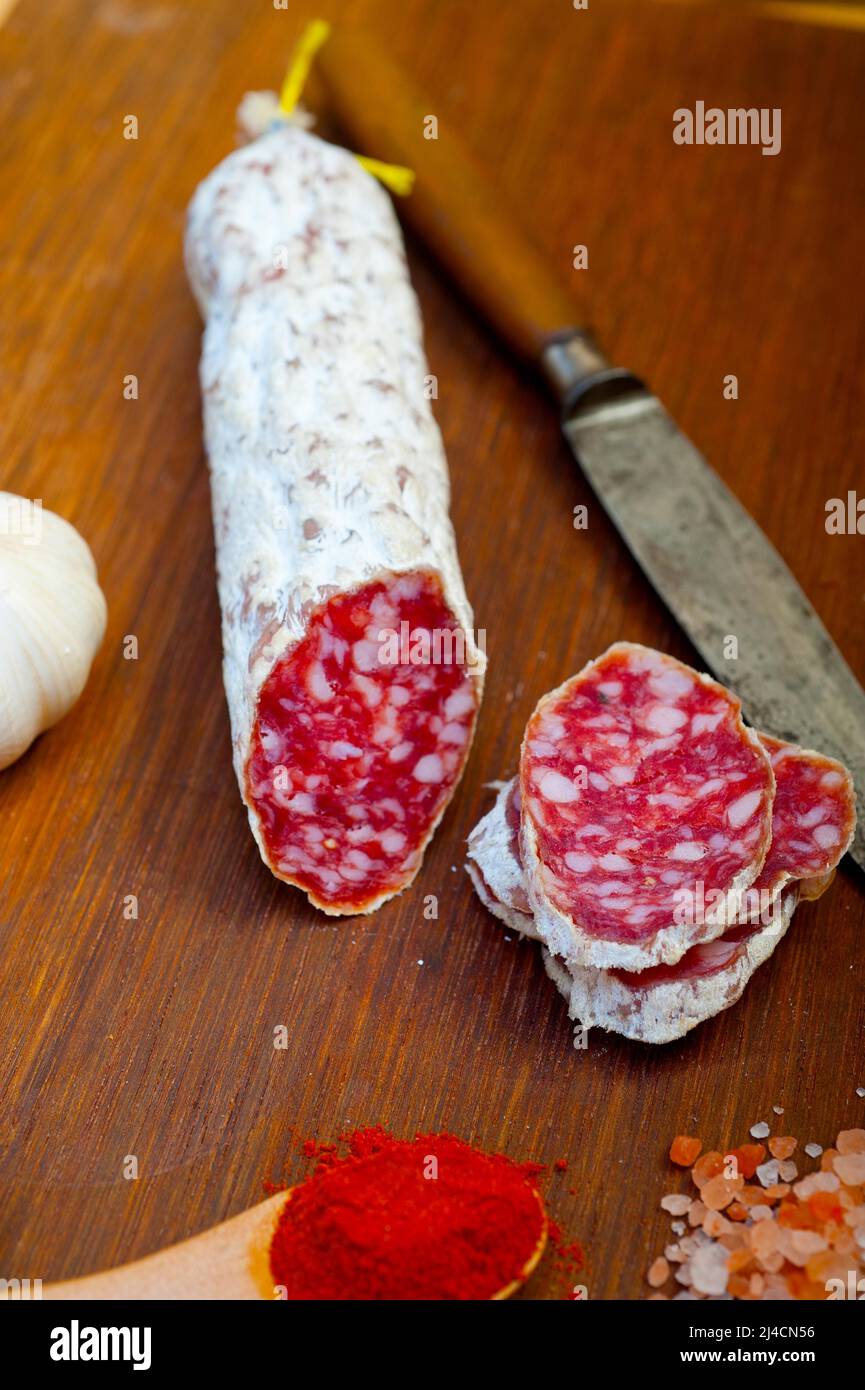 Traditional Italian salame cured sausage sliced on a wood board Stock ...