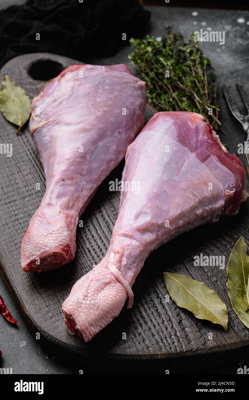 Fresh turkey legs with ingredients for cooking set, on black dark stone ...