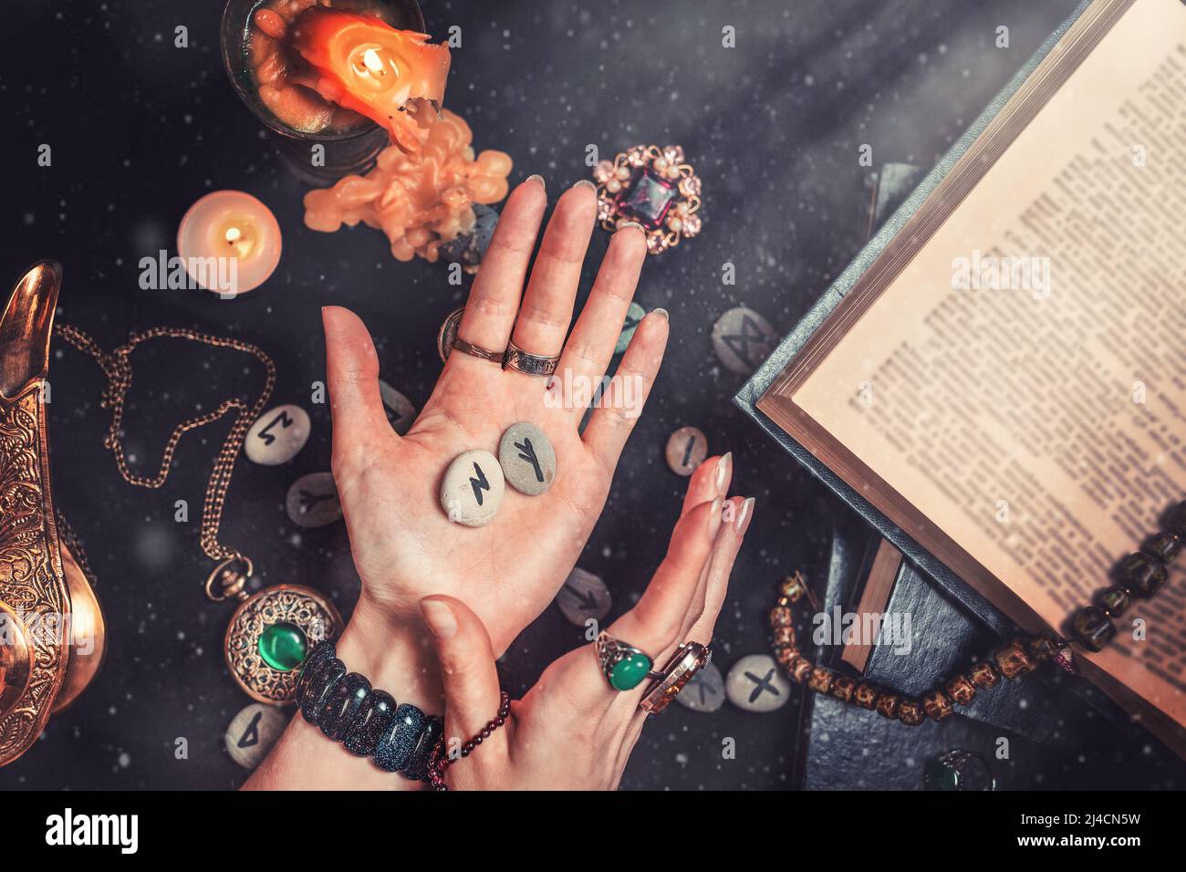Astrology and esotericism. The witch is holding in his hands the rune ...