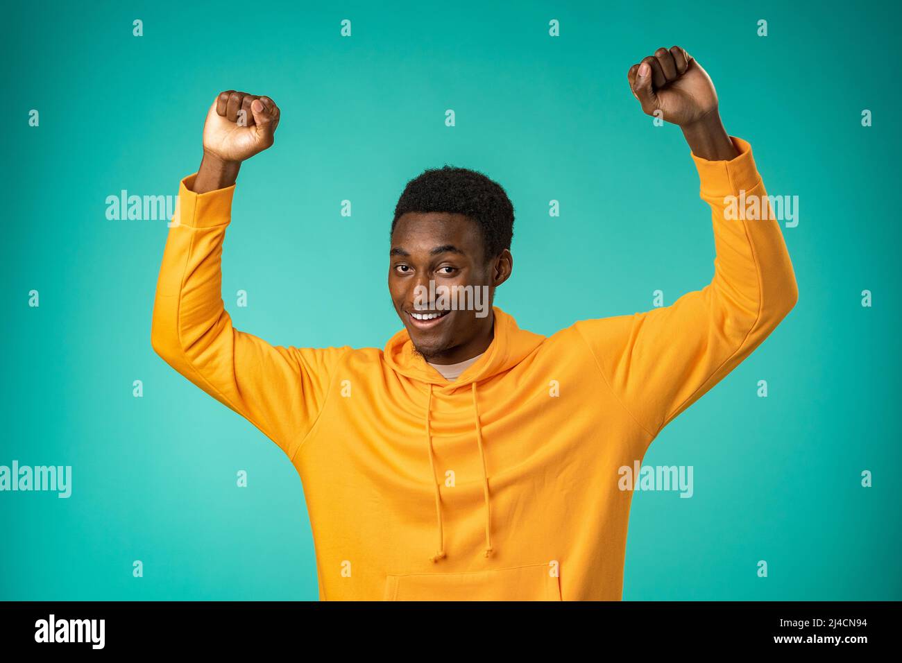 Portrait of overjoyed black man celebrating success in studio Stock ...