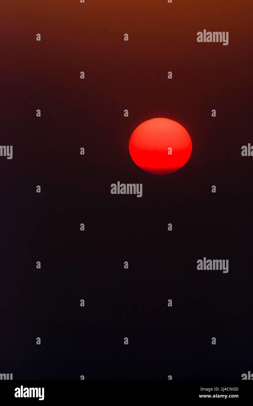 Red ball of the setting sun, Bavaria, Germany Stock Photo - Alamy