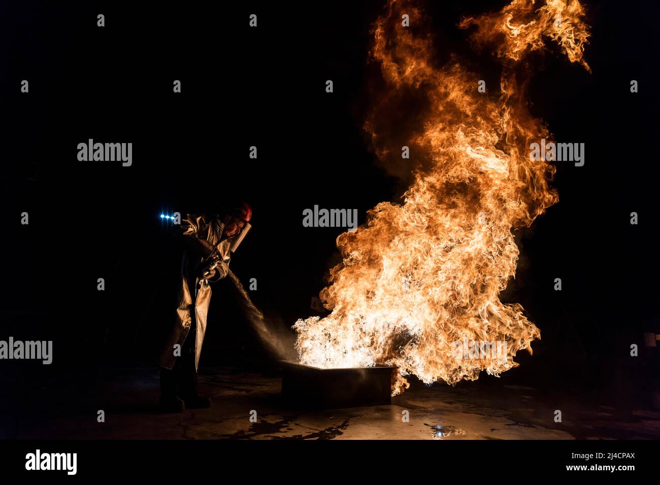 Firefighter extinguishes a heptane 2B-Pan fire with a 2-BTP ...