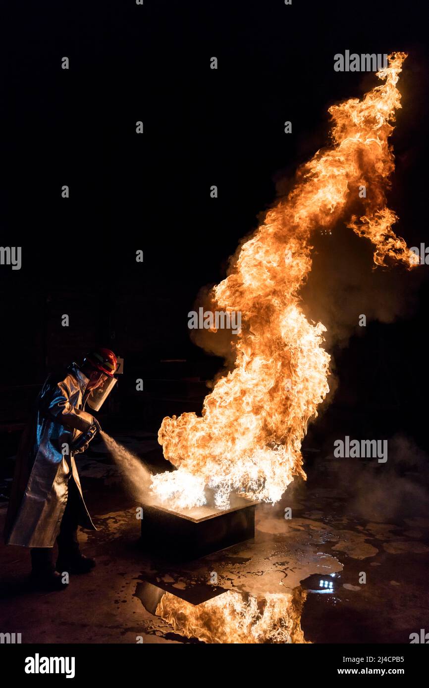 Firefighter extinguishes a heptane 2B-Pan fire with a 2-BTP ...