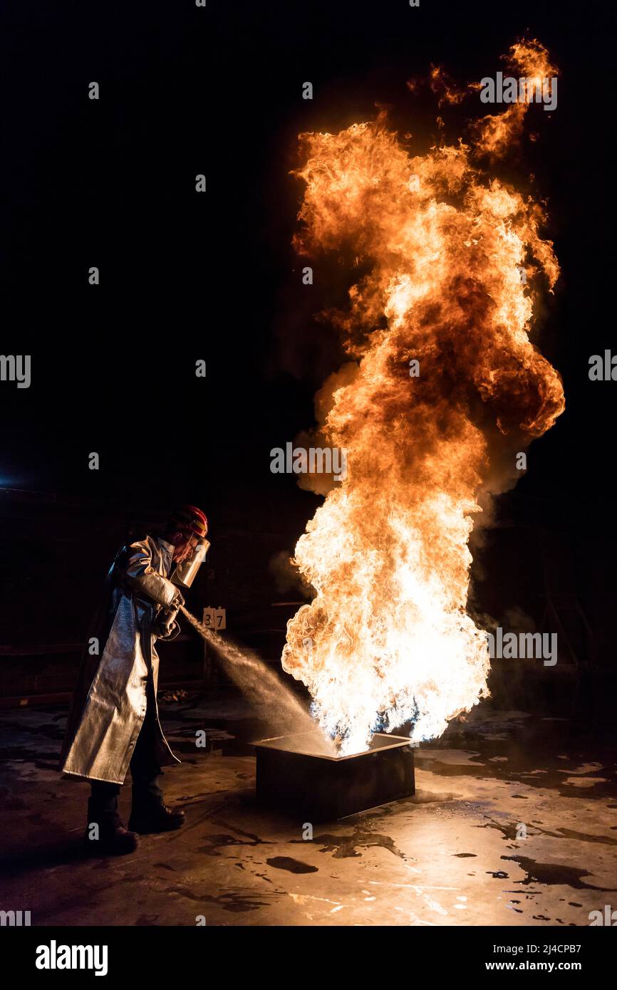 Firefighter extinguishes a heptane 2B-Pan fire with a 2-BTP ...