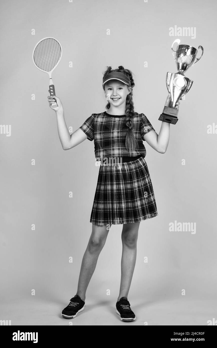 teen kid in fitness cap holding tennis or badminton racket and ...