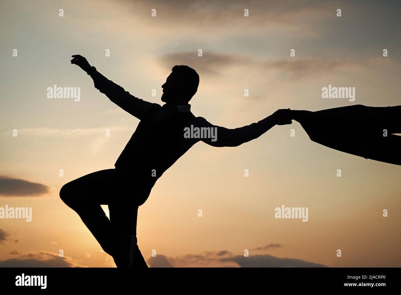 silhouette of man dancing in sense of freedom on sunrise sky, free ...