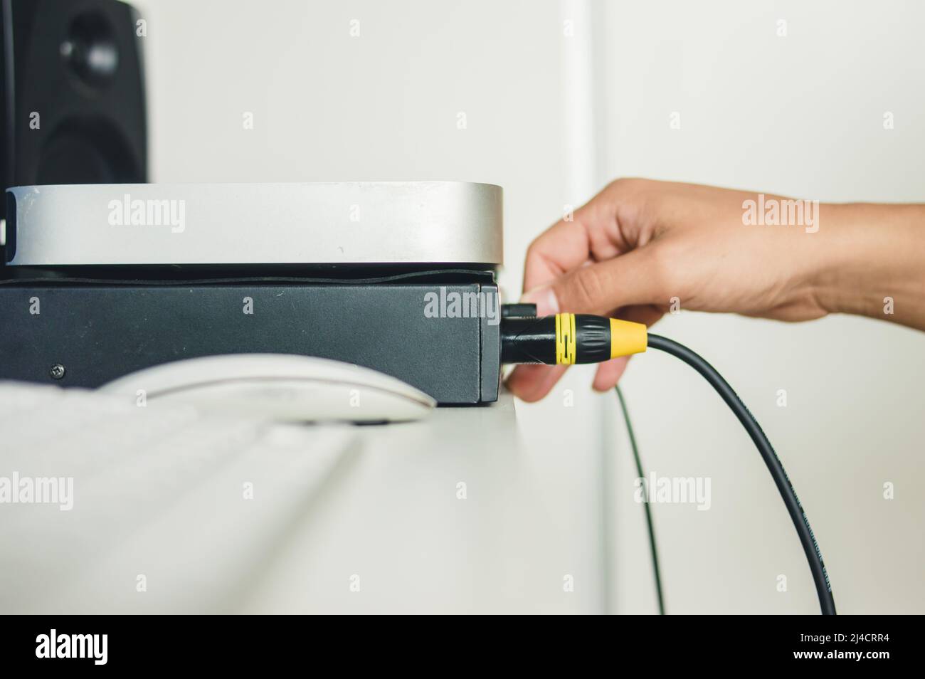 male hands in home studio moving the controls of an audio interface to ...