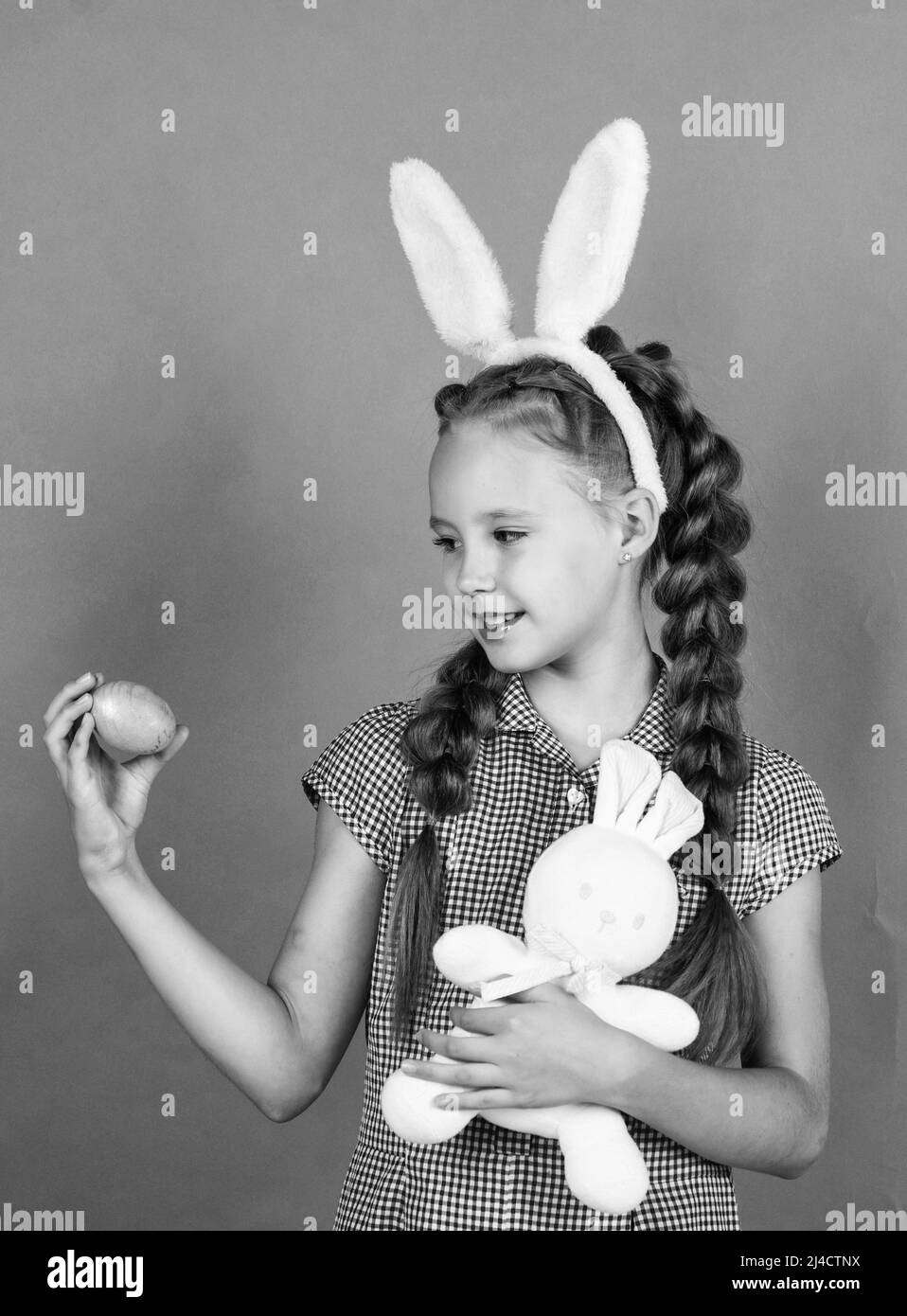 happy teen girl in bunny ears hold rabbit toy and egg, happy easter ...