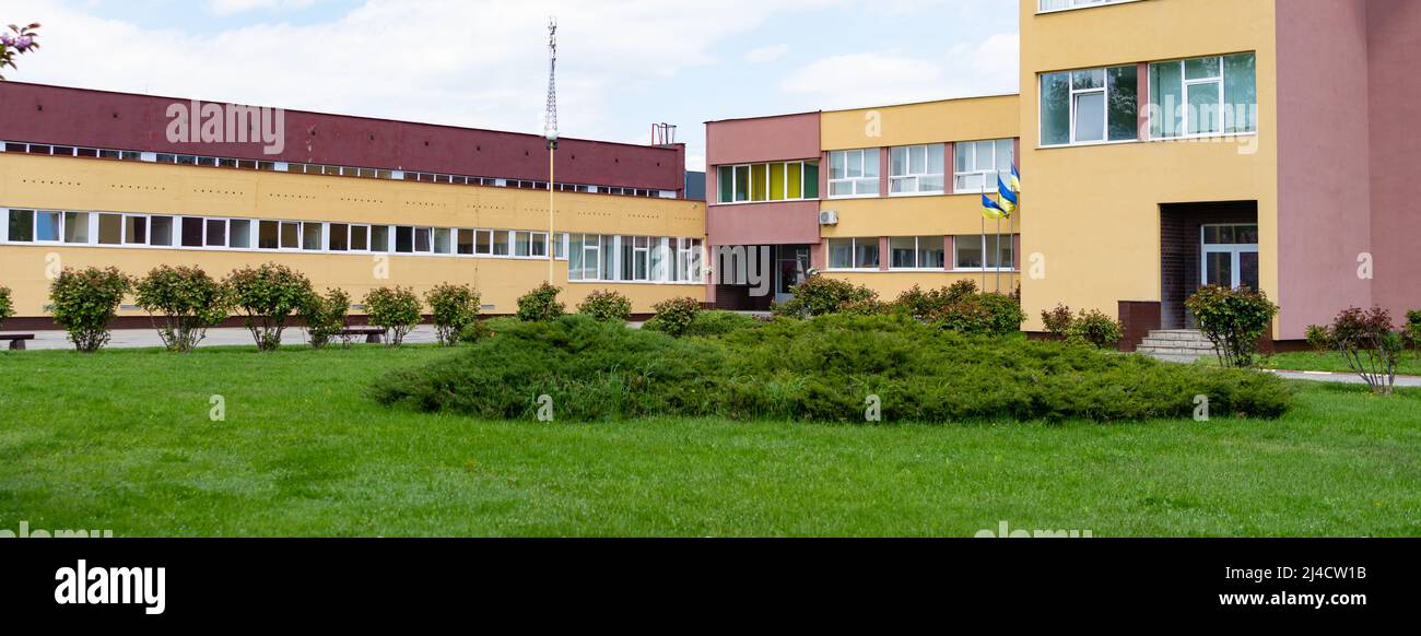 School building architecture exterior around courtyard with green space ...