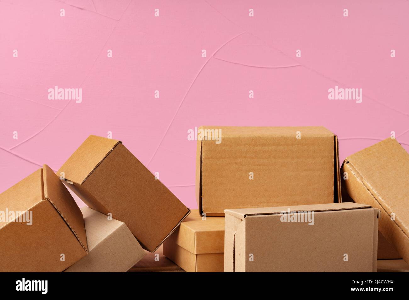 Set of cardboard boxes on pink background Stock Photo - Alamy