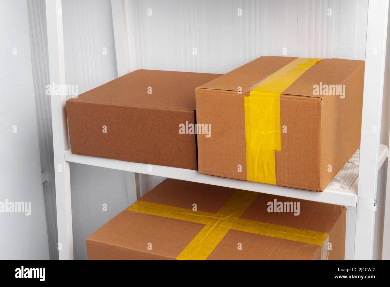 Stack of cardboard package boxes on wooden rack Stock Photo - Alamy