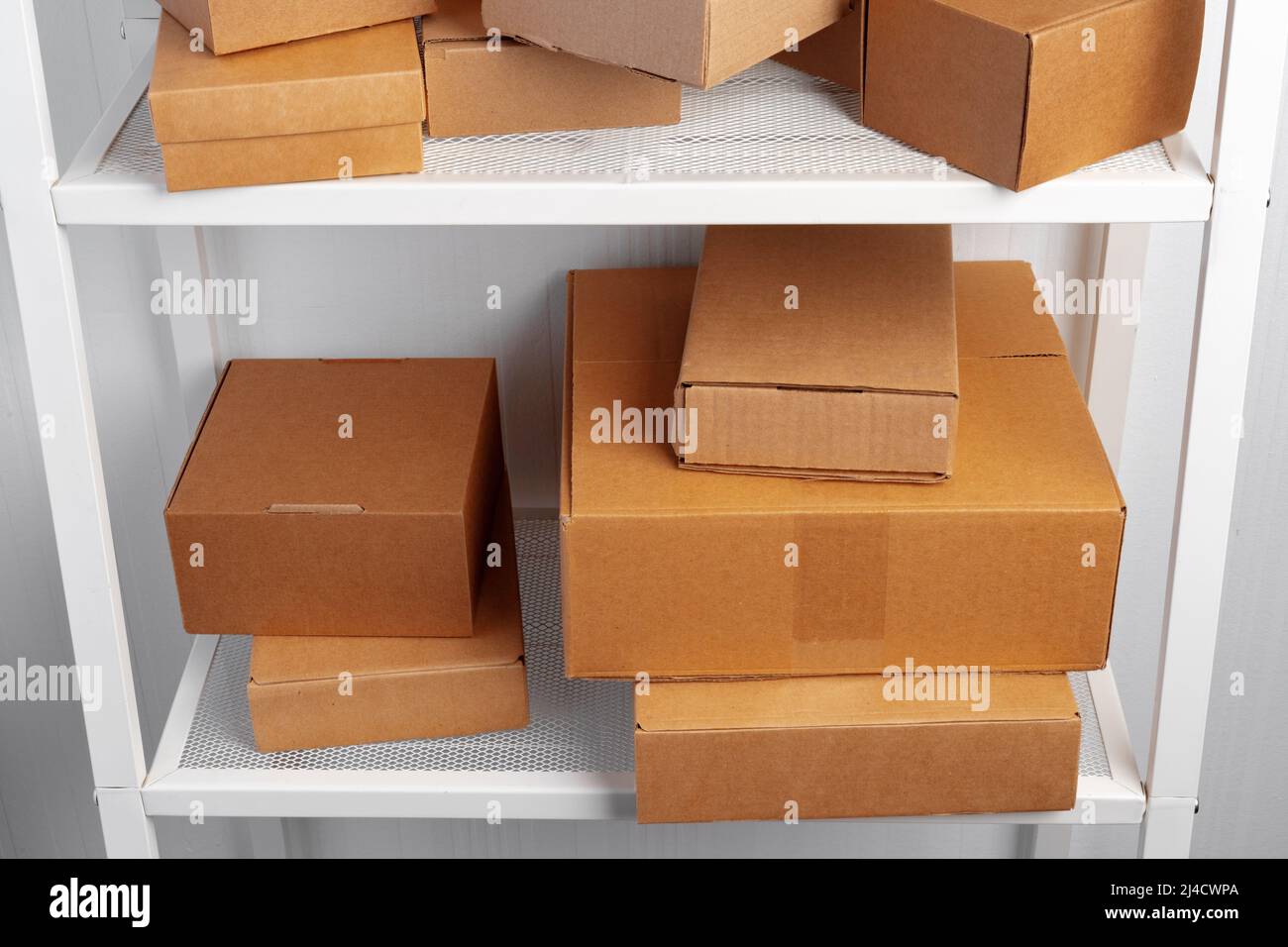 Stack of cardboard package boxes on wooden rack Stock Photo - Alamy