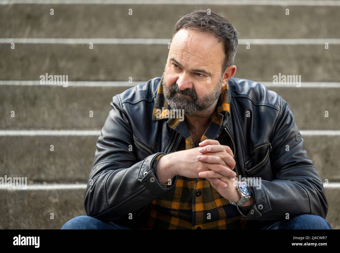 Berlin, Germany. 11th Apr, 2022. Actor Tom Keune sits on a staircase in ...