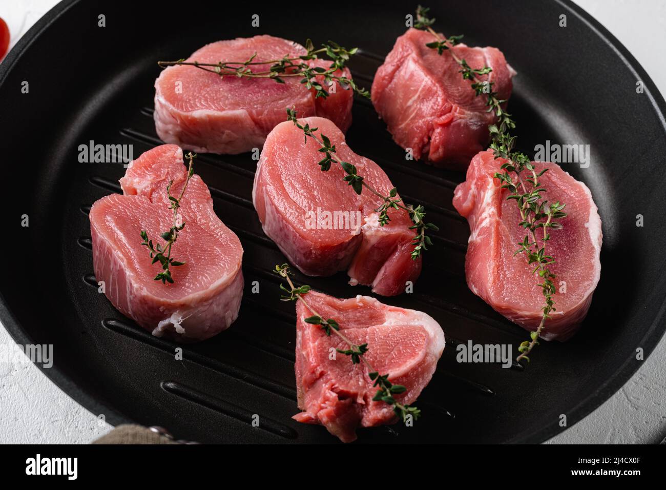 Raw pork fillet, on white stone table background Stock Photo - Alamy
