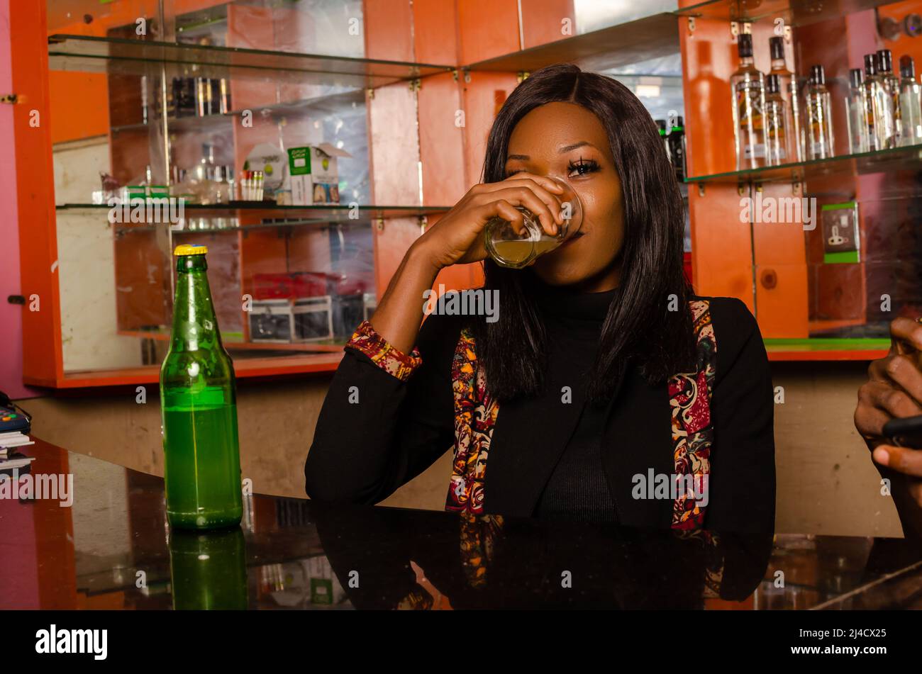 beautiful lady in the bar having some drink Stock Photo - Alamy