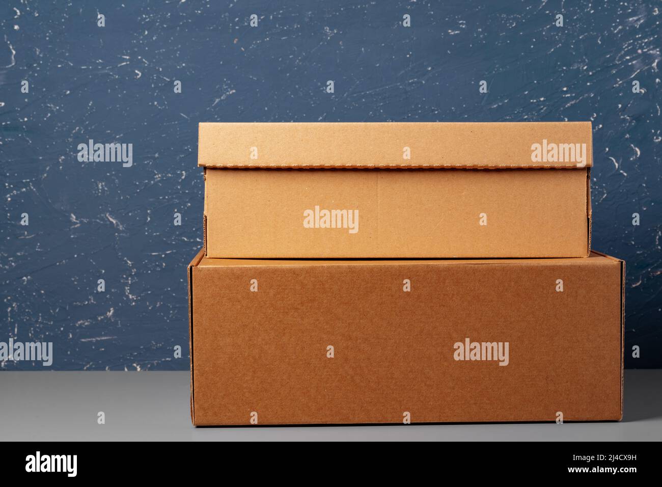 Group of cardboard boxes against blue background Stock Photo - Alamy
