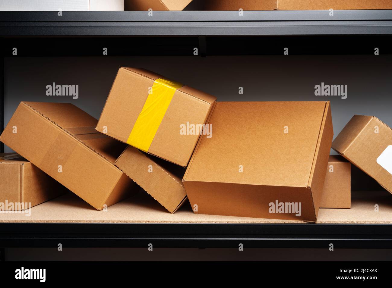 Rows of shelves with cardboard boxes in modern warehouse Stock Photo ...