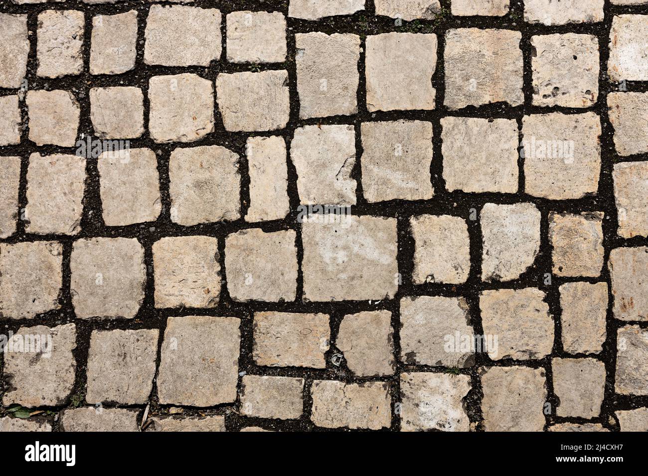 Mosaic of small marble cubes. sidewalks and squares formed by stone ...