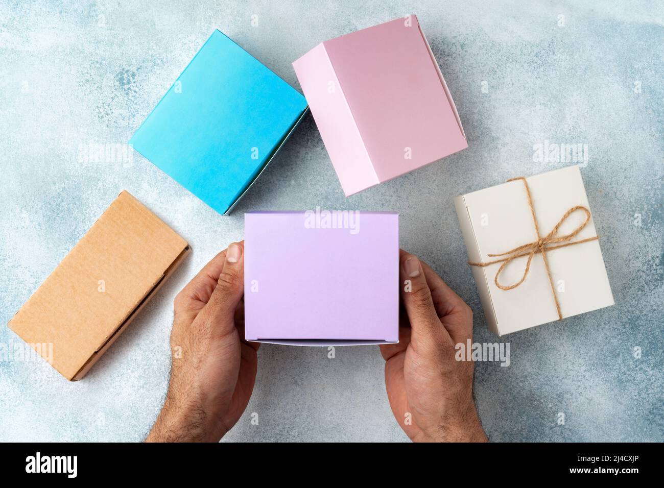 Parcel cardboard box in a man hands on a gray table background Stock ...