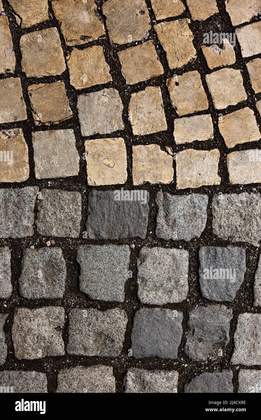 Mosaic of small marble cubes. sidewalks and squares formed by stone ...