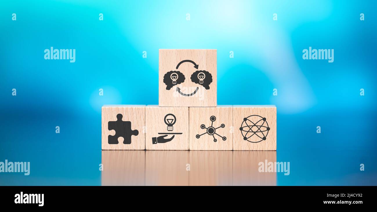 Wooden blocks with symbol of knowledge sharing concept on blue ...