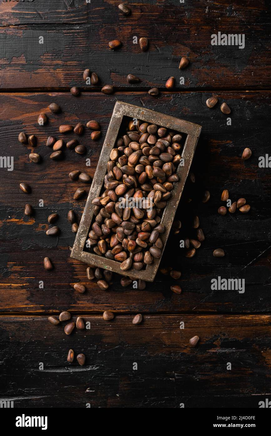 Pine wild organic nut set, on old dark wooden table background, top ...