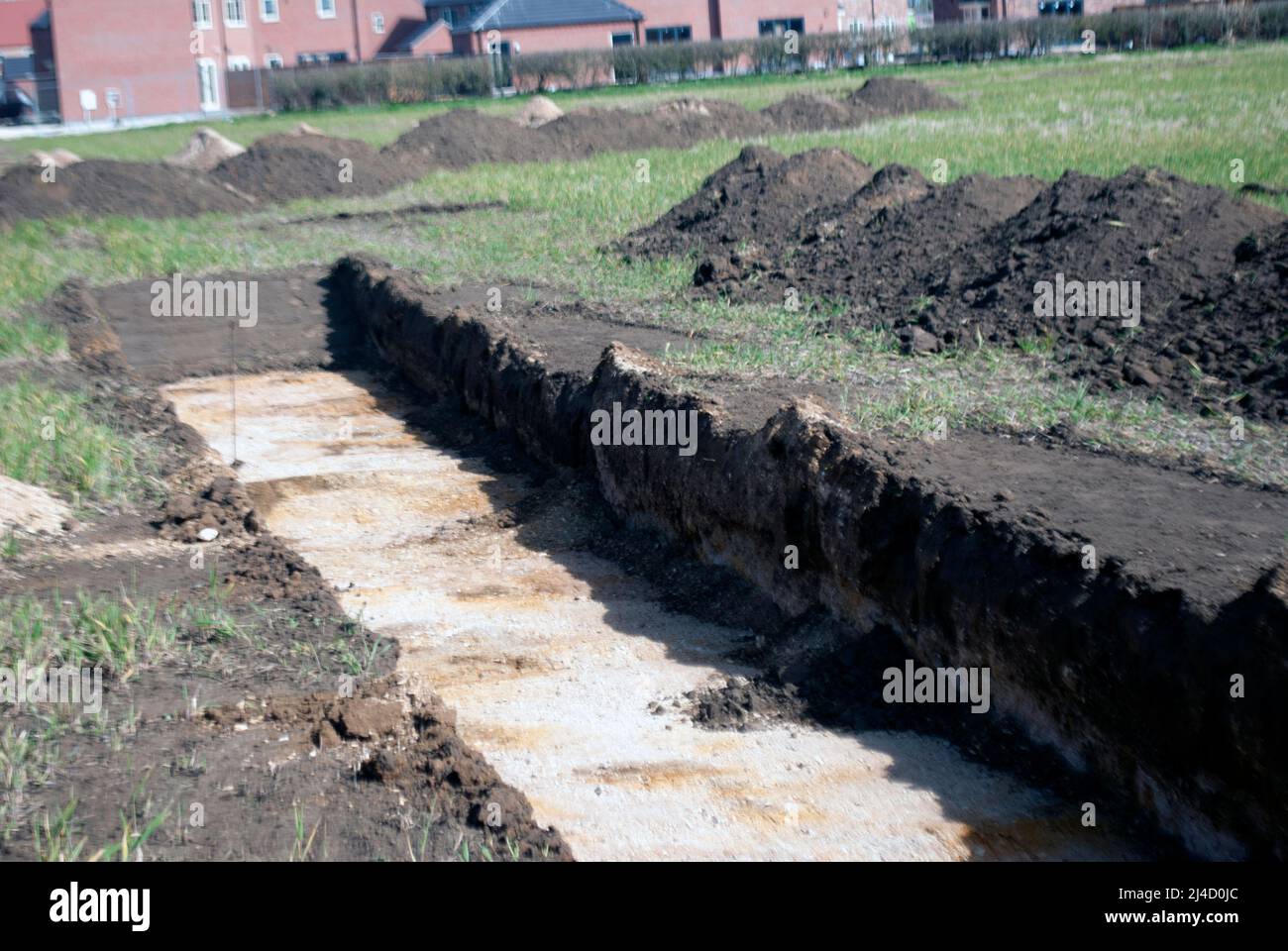 Trenches dug in field for archaeological survey next to village of ...