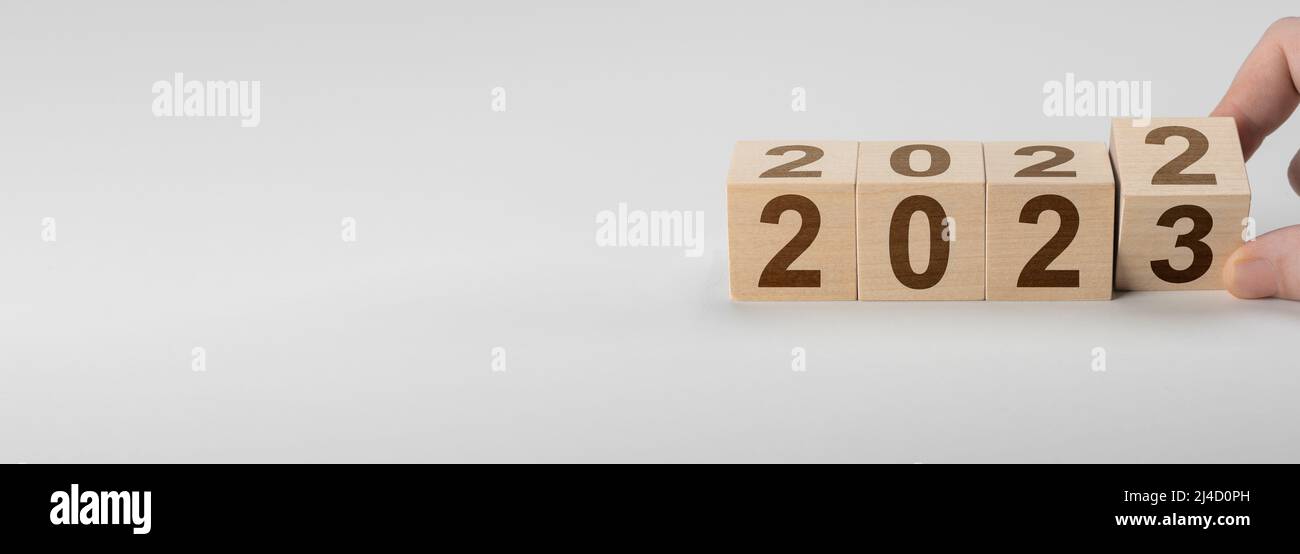 happy new year concept, Flipping of wooden cube block change from 2022 to 2023. Wooden cube with ...