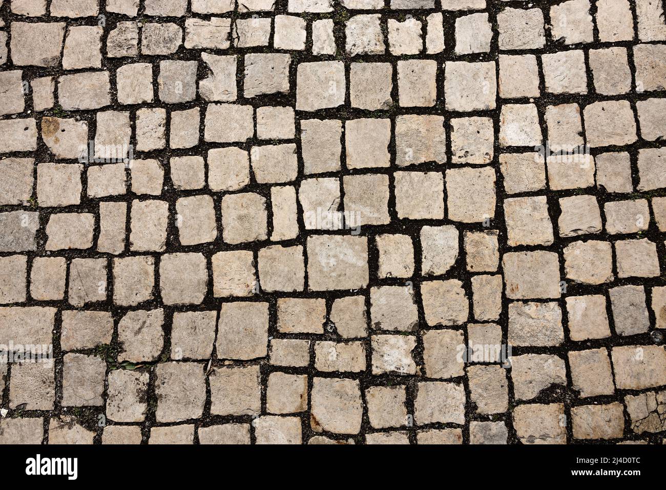 Mosaic of small marble cubes. sidewalks and squares formed by stone ...