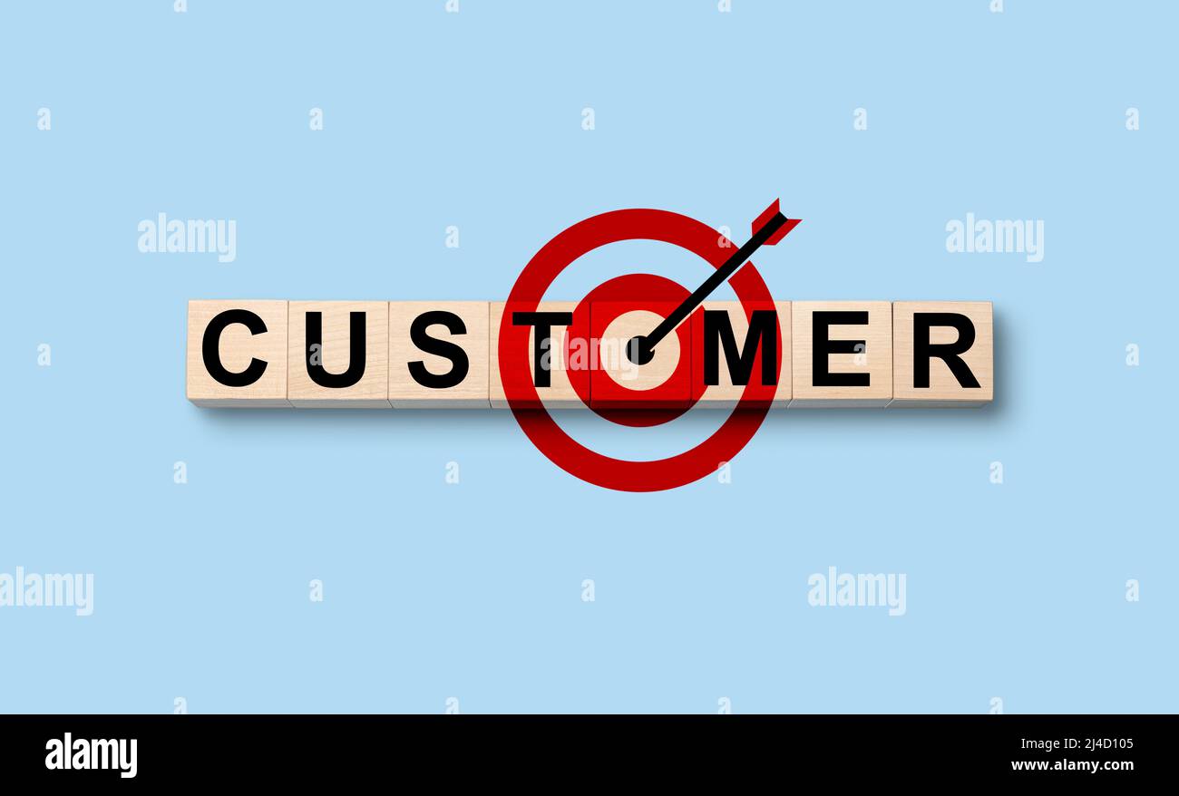 Customer wording on wooden cube block with red target board with arrow ...