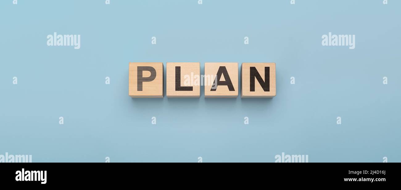 Plan word on wooden cubes. Goals, success, strategy, solution ...