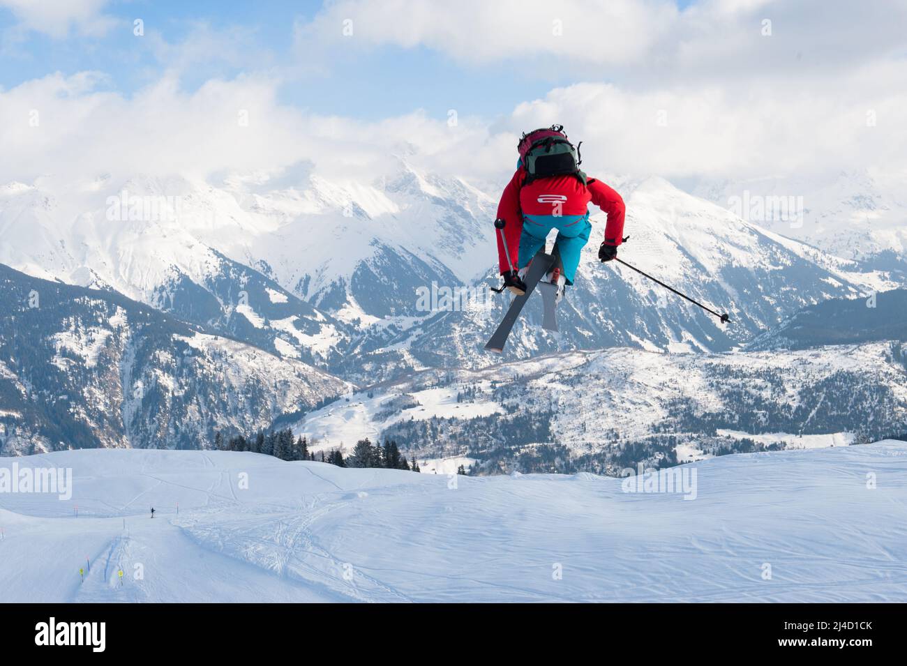 Skier jumping towards mountains Stock Photo - Alamy