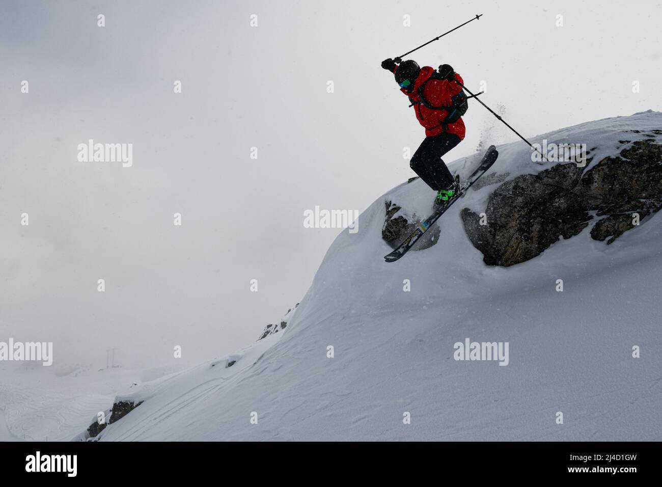 Skier flying over a powdery slope Stock Photo - Alamy