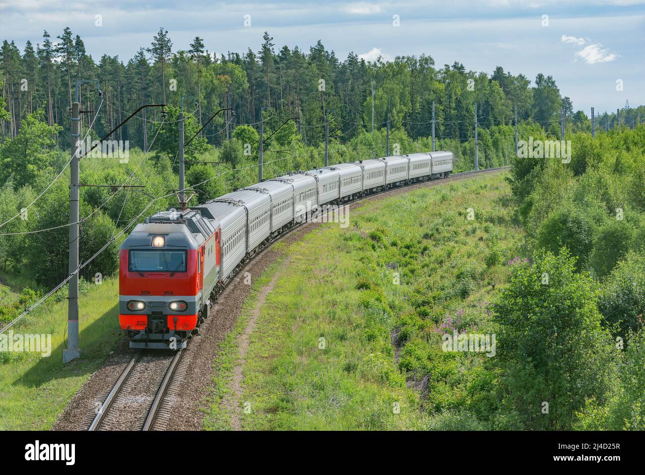 Passenger train moves at summer morning time Stock Photo - Alamy