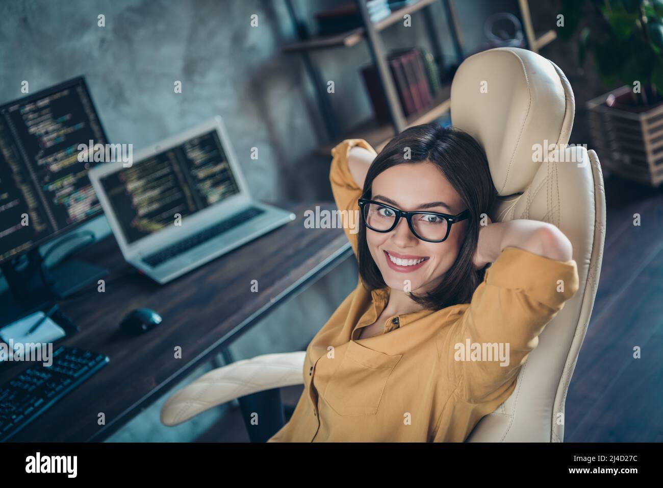 Portrait of attractive cheerful girl geek hacker sitting resting in ...