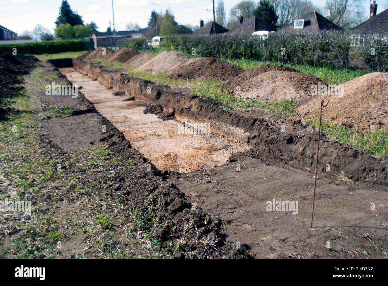 Trenches dug in field for archaeological survey next to village of ...