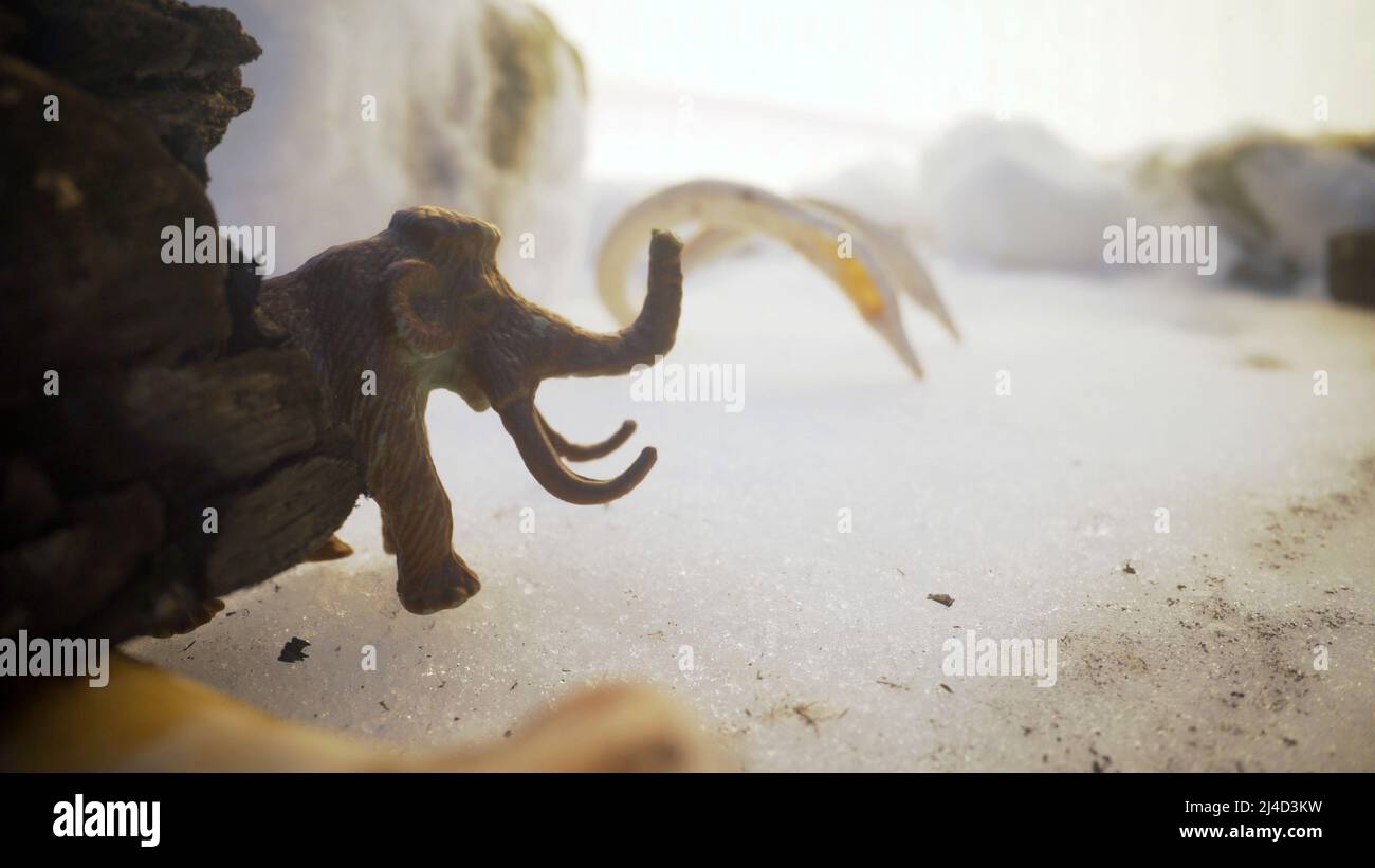 Mammoth toy in the snow. Mammoth in a cold snowy landscape Stock Photo ...
