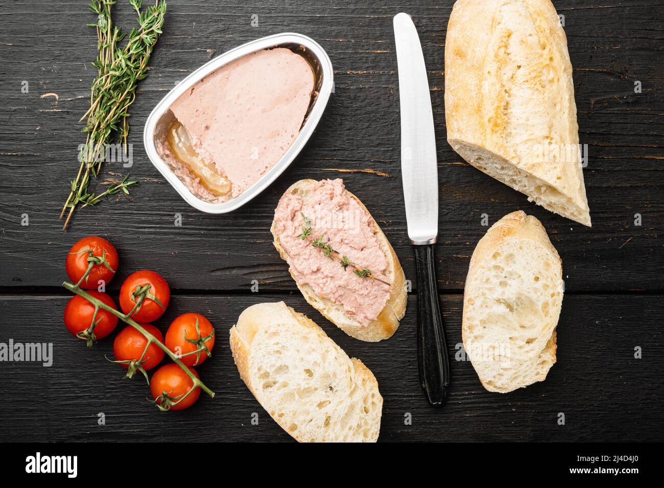 Liver pate on toast set, on black wooden table background, top view ...