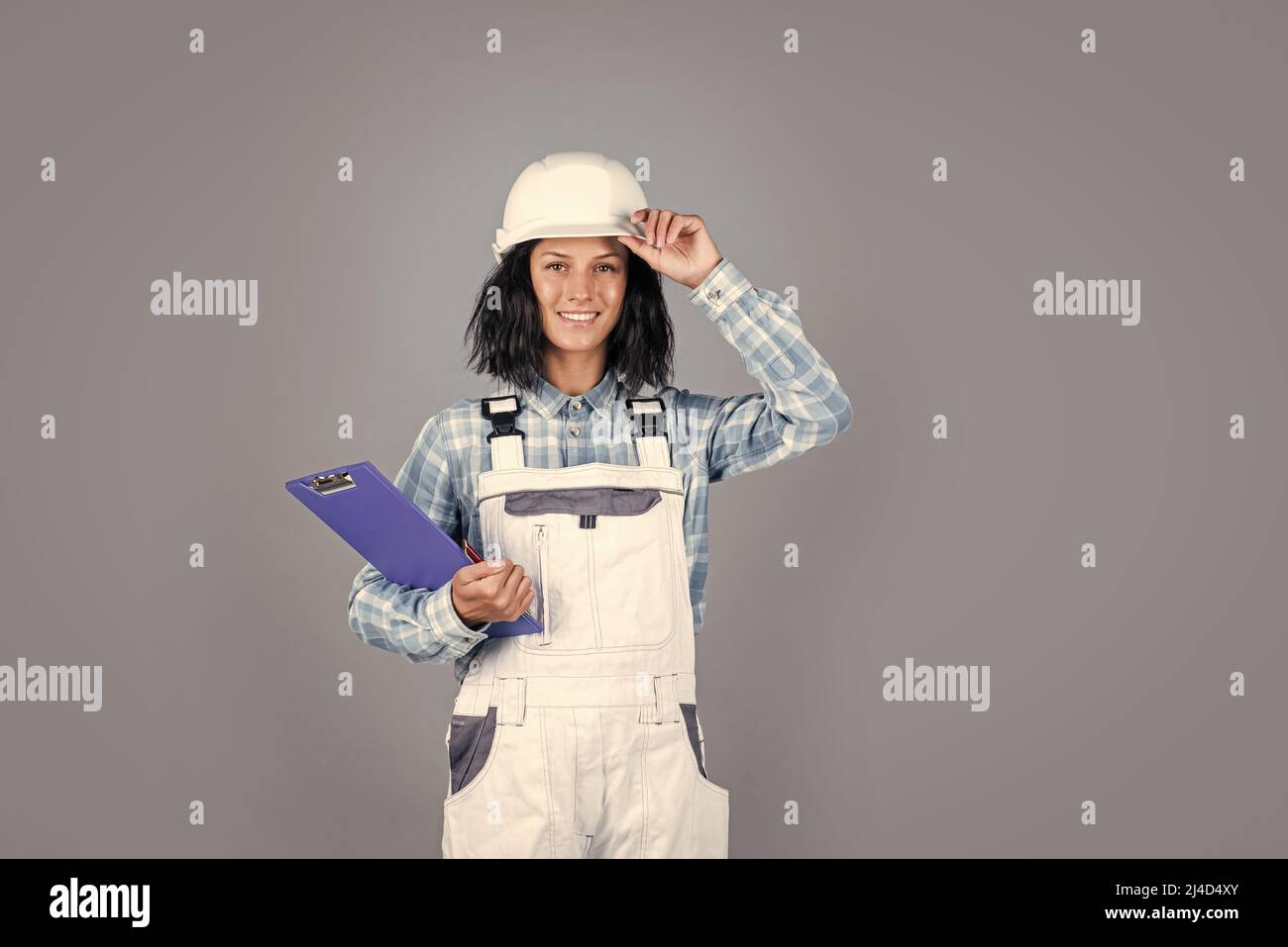 Built with excellence. carpenter assistant wear protective helmet. girl ...