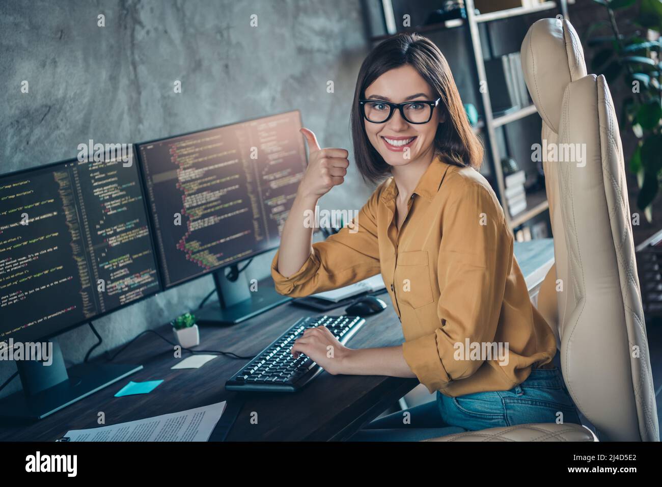 Portrait of beautiful cheery girl expert developing web project showing ...